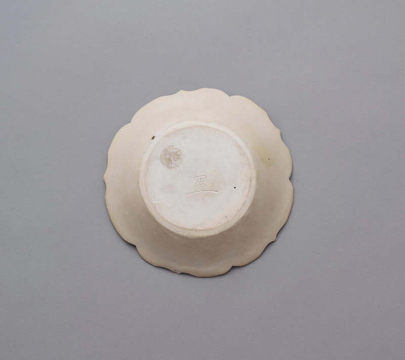 An inscribed Xing white-glazed foliate-rim dish, Tang Dynasty (AD 618 ...