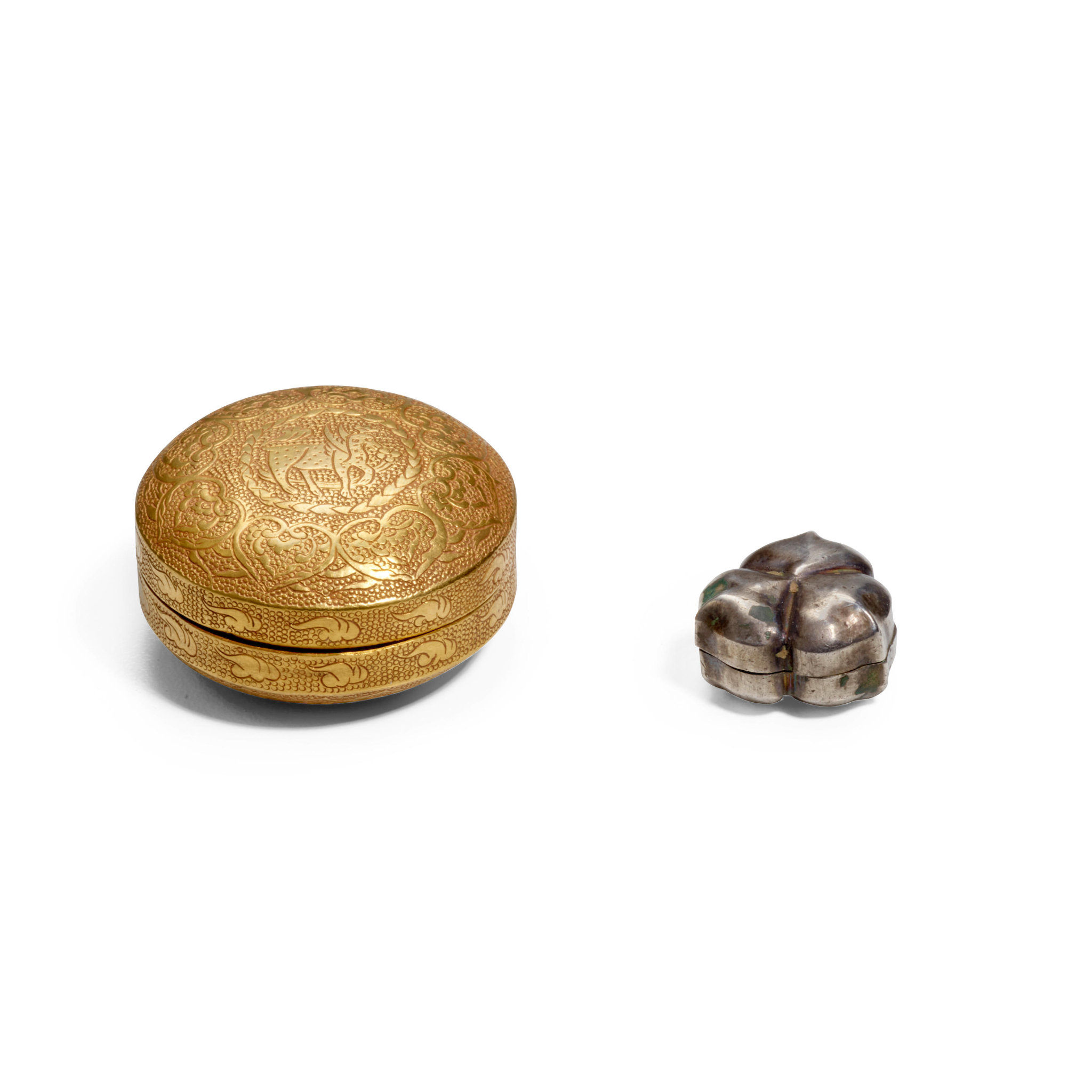 A small engraved gold circular box and a miniature silver trefoil box ...