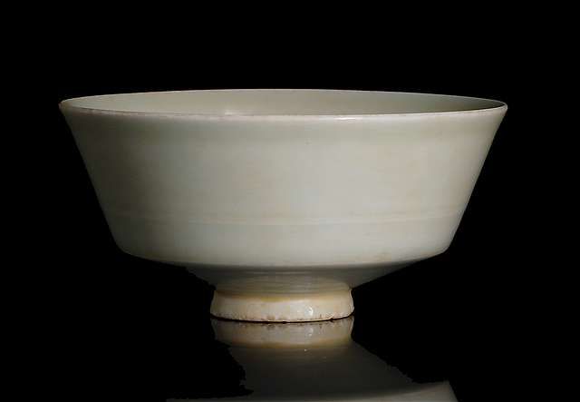 A porcelain bowl with moulded dragon décor, China, marked Shufu, Yuan ...