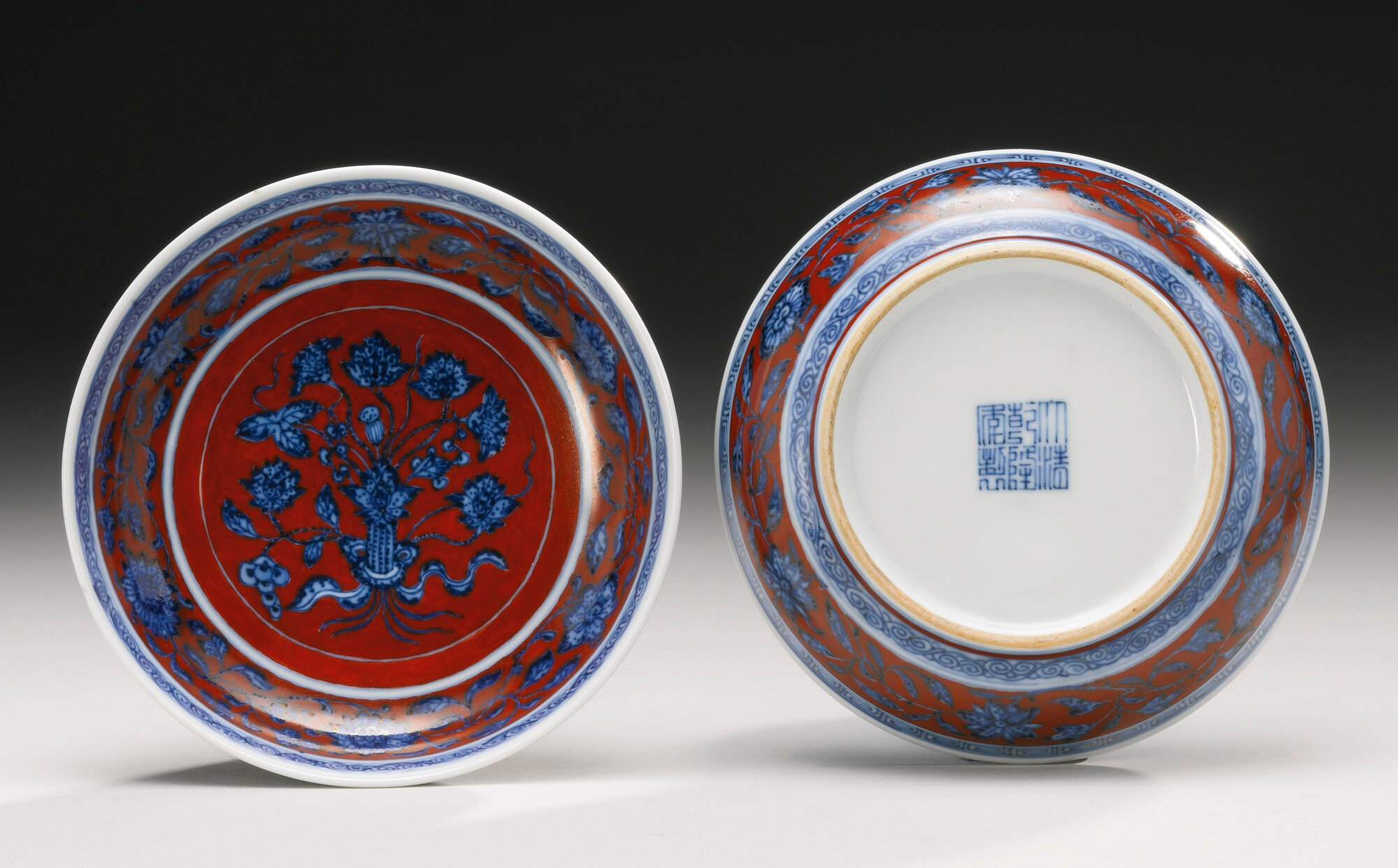 A rare pair of Ming-style underglaze blue iron-red-ground dishes ...